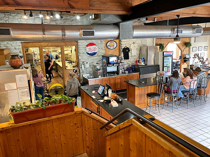 Inside, wooden beams and stone walls create that perfect blend of mountain charm and casual dining comfort. Pizza paradise awaits.