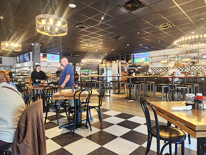 Black and white checkered floors set the stage for culinary drama, where modern lighting fixtures illuminate Delaware's answer to breakfast paradise.