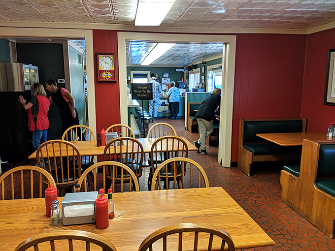 Red walls, wooden chairs, and the promise of something magical. This dining room has witnessed countless barbecue epiphanies since 1962.