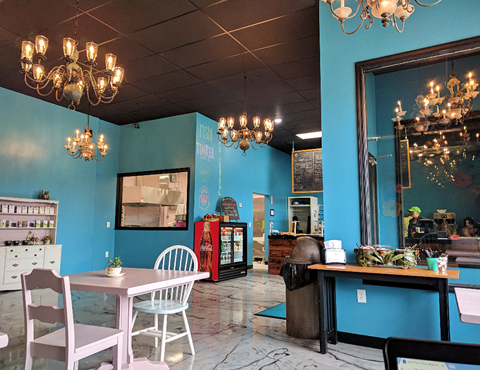 Chandeliers and teal walls create an unexpected elegance. Who knew donut consumption could feel so fancy? Marie Antoinette would approve.
