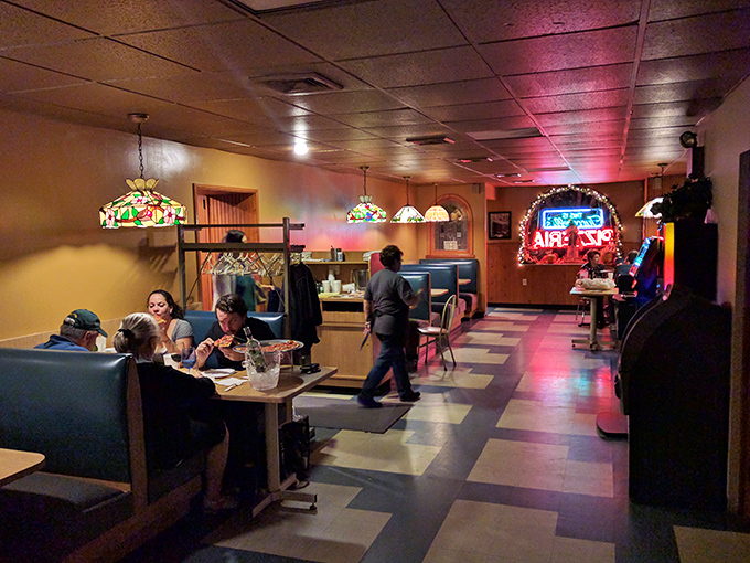 Holiday garlands meet Tiffany lamps in this no-frills dining room where conversations about dough quality have been happening since before Instagram existed.