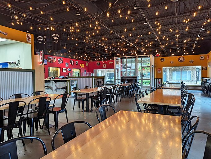 Edison bulbs cast a warm glow over wooden tables, creating that perfect "we're serious about meat, not d&eacute;cor" atmosphere every great BBQ joint needs.