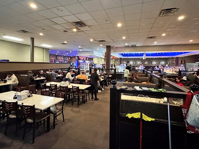 Spacious seating and ambient blue lighting create the perfect backdrop for your impending food marathon. Strategic table placement means less awkward buffet-line dancing.