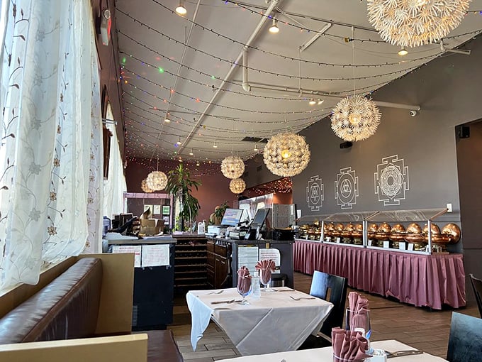 Dandelion-inspired light fixtures float above diners like magical spice pods, while the buffet awaits with copper vessels of culinary treasures.
