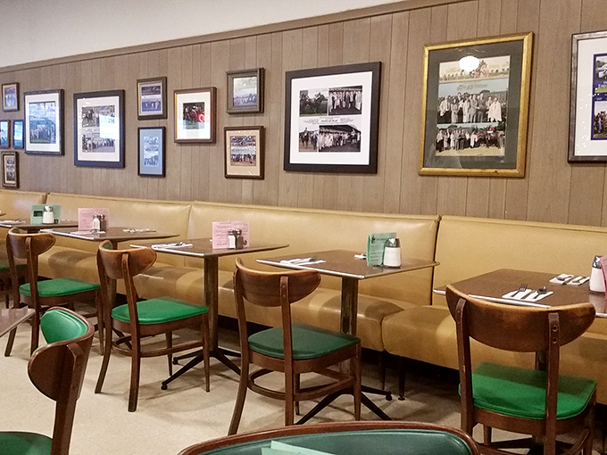 Time-travel via breakfast! Wood paneling, vintage photos, and those unmistakable green vinyl chairs create the diner equivalent of a warm hug.