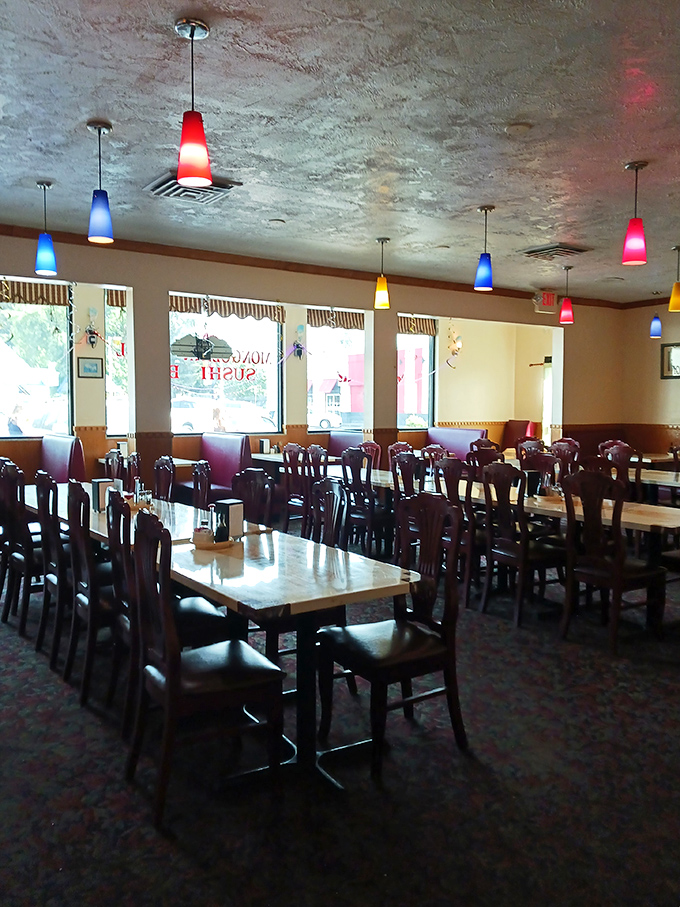 Colorful pendant lights cast a warm glow over the dining area, creating an inviting atmosphere where food comas are born.