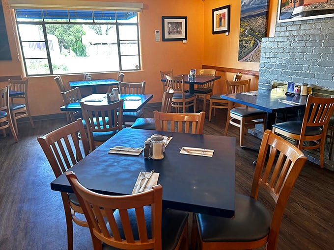 Simple wooden chairs and warm orange walls create that perfect "come as you are" vibe where both locals and tourists feel equally at home.