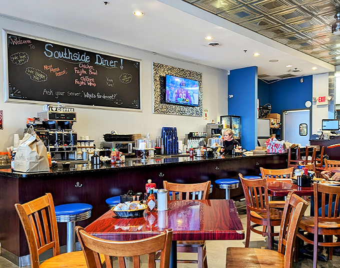 Blue walls and wooden tables set the stage for breakfast theater where coffee refills appear like magic before you realize you need one.