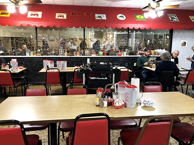 Red vinyl chairs and farming memorabilia create the perfect backdrop for morning conversations. No design consultants required, just decades of getting it right.