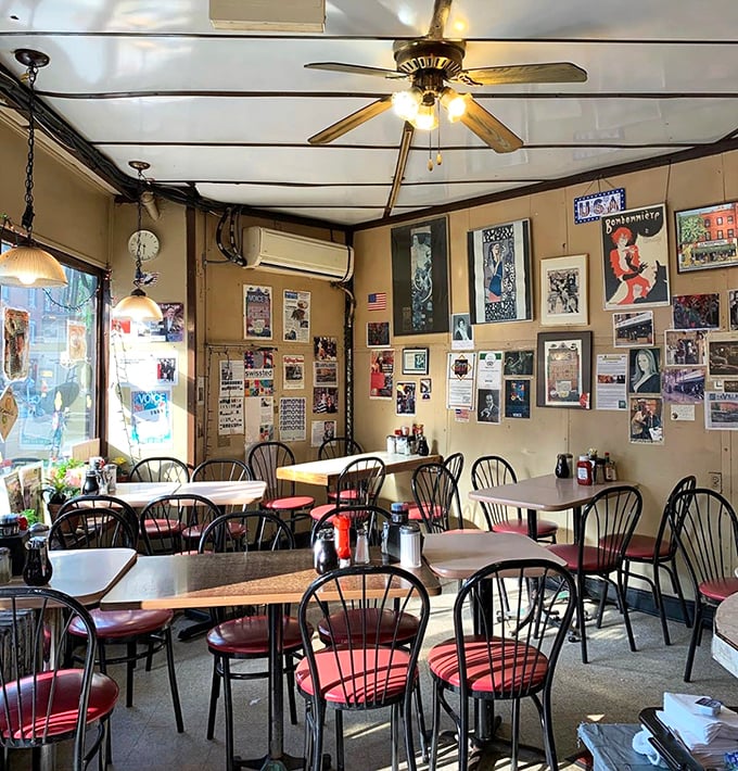 Inside, memory-filled walls tell decades of New York stories while ceiling fans lazily spin overhead, cooling conversations that have endured longer than most Manhattan restaurants.