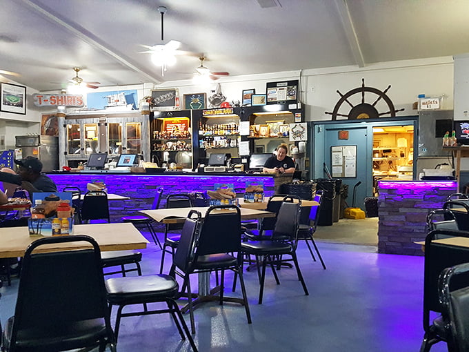 The nautical-themed interior with its purple-lit bar creates an atmosphere that says, "We're serious about seafood, not interior design."
