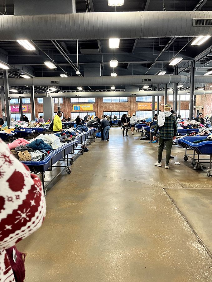 Blue bin battlefield where treasure hunters strategically navigate rows of potential finds. The thrill of the hunt is palpable in this warehouse wonderland.