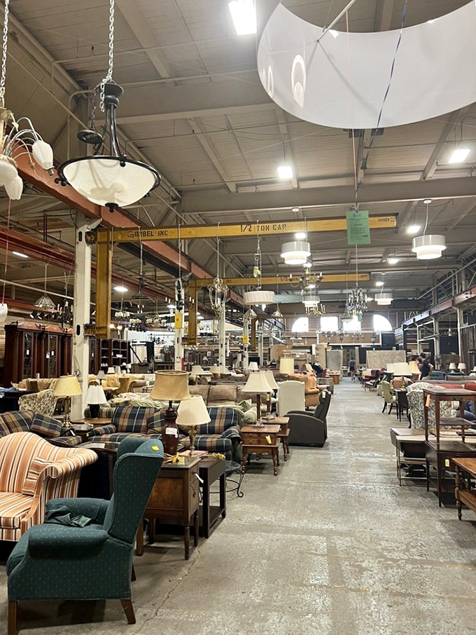 Chandeliers hang like crystal constellations above an endless sea of furniture possibilities. Your next living room is somewhere in this glorious chaos.