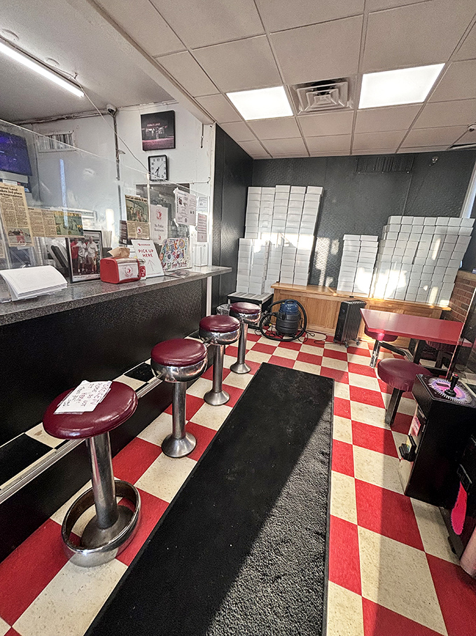 Looks like someone hit the retro jackpot&mdash;red vinyl stools, checkerboard floors, and enough boxes to stage a carb-fueled Broadway show.