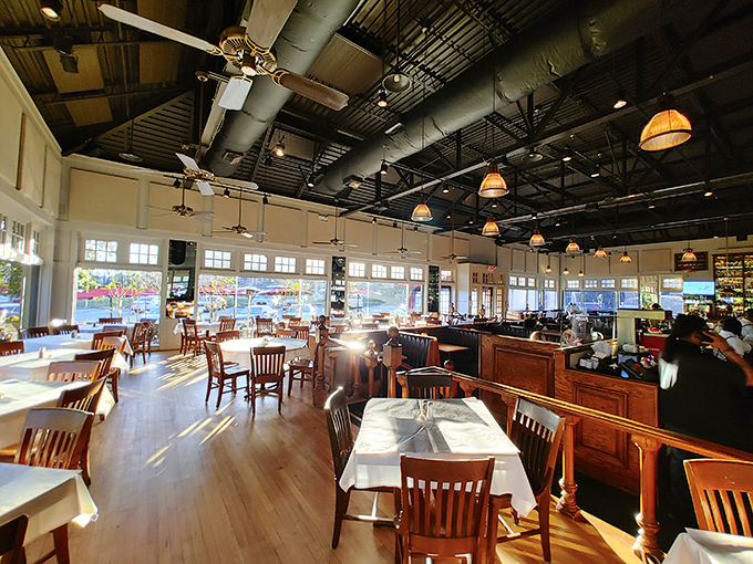 Sunlight streams across wooden floors and white tablecloths, creating that magical space where "fancy" meets "I could totally take a nap here after my meal."