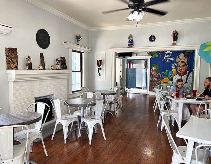 Where home meets heritage&mdash;bright white chairs against warm wood floors create the feeling you've been invited to dinner at a stylish friend's house.
