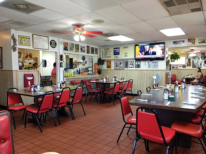 Red vinyl chairs and wood-paneled walls create that perfect diner atmosphere where conversations flow as freely as the coffee refills.