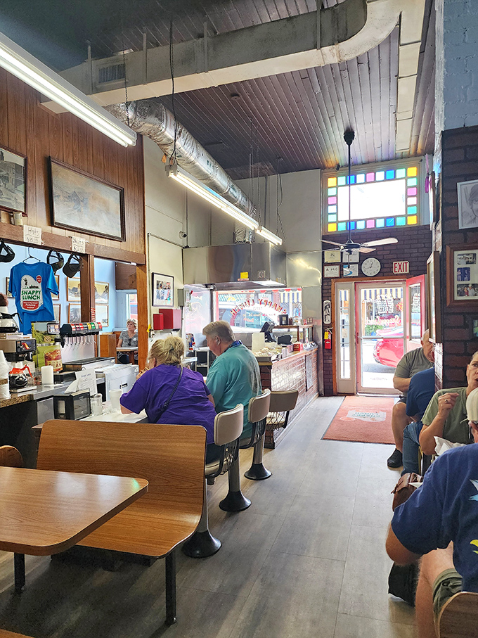 Inside, the counter seats are where memories are made. Wood-paneled walls and exposed ductwork tell the story of a place untouched by pretension.