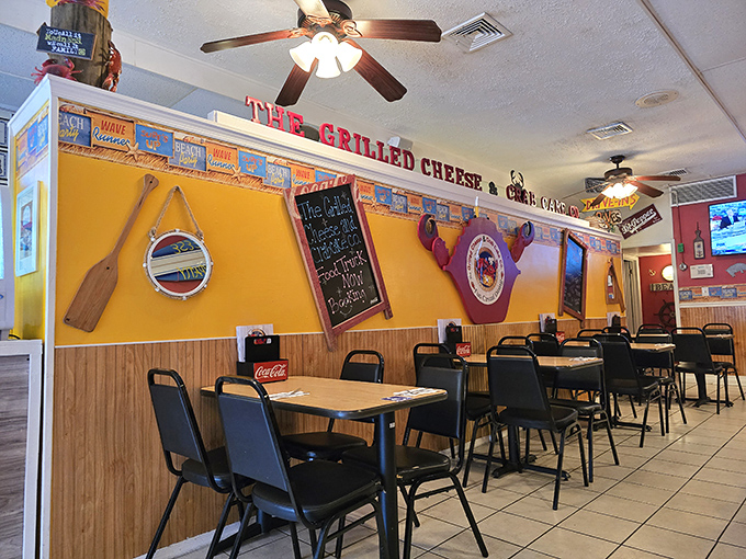 Sunny yellow walls adorned with beach-themed decor create the perfect backdrop for serious comfort food indulgence.