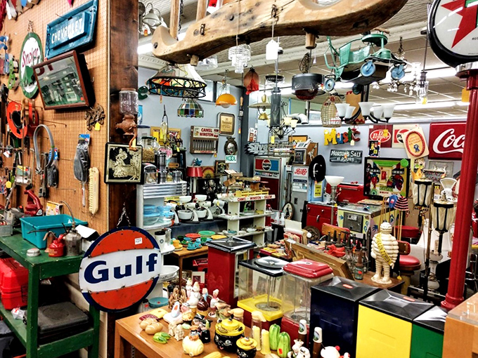 The vibrant red walls serve as the perfect backdrop for crystal chandeliers hanging above curated living room displays. Home design magazines eat your heart out!
