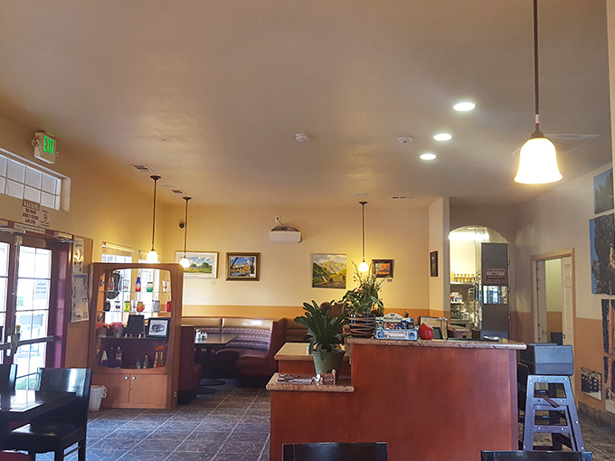 Golden walls, pendant lighting, and local artwork create that warm, welcoming glow that only the best hometown restaurants seem to master.