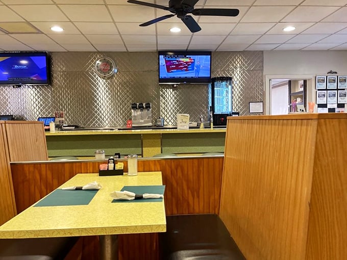 Classic diner booths where strangers become neighbors and the wood paneling has witnessed more local gossip than a small-town barber shop.