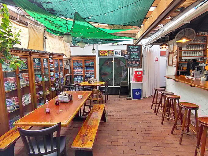 Step inside to find brick floors and wooden tables that have witnessed decades of morning conversations, where ceiling tarps create the perfect blend of indoor-outdoor Keys living.