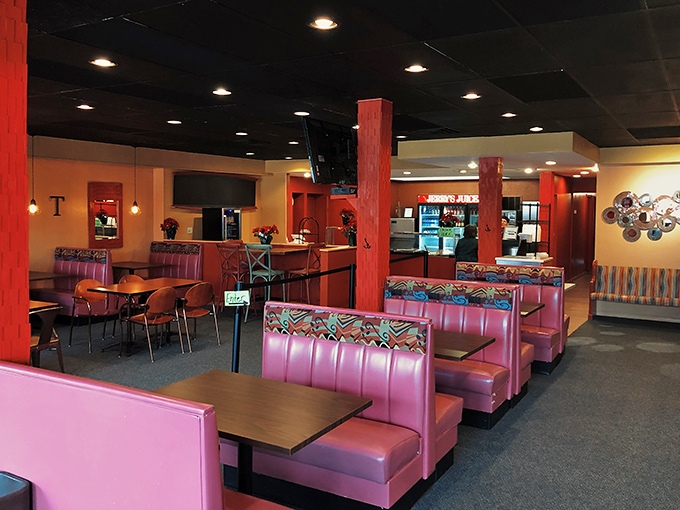 Pink vinyl booths and warm wood tones create the perfect backdrop for the comfort food drama about to unfold on your plate.