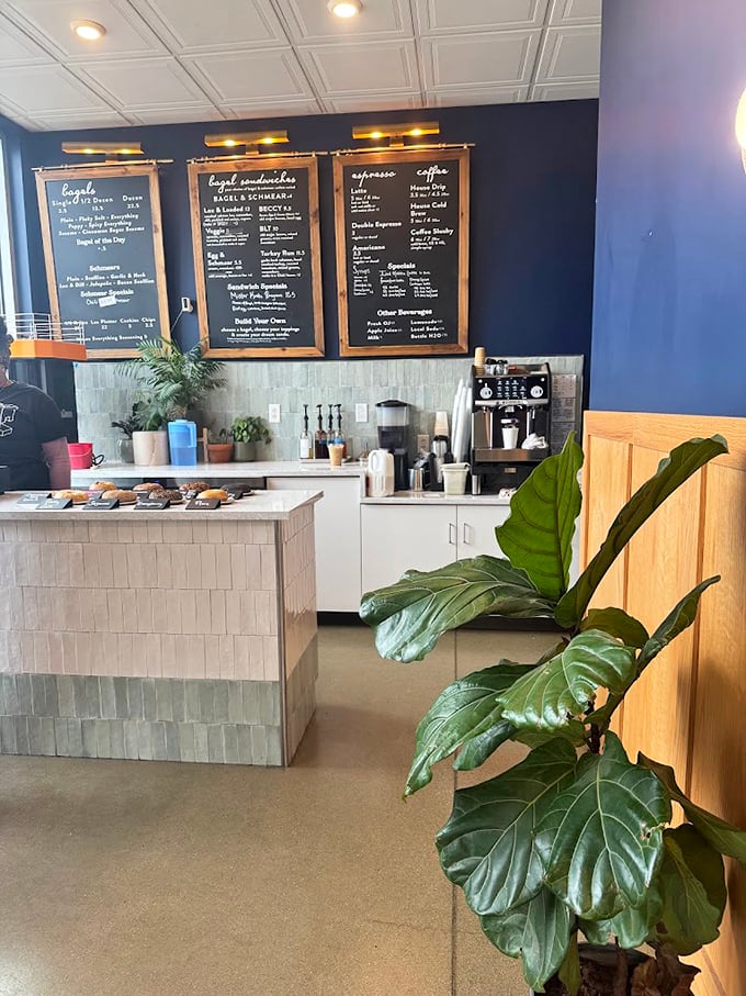 Navy blue walls and white tile create the perfect backdrop for bagel artistry. Like a well-designed jazz club, but the solos are performed with dough.