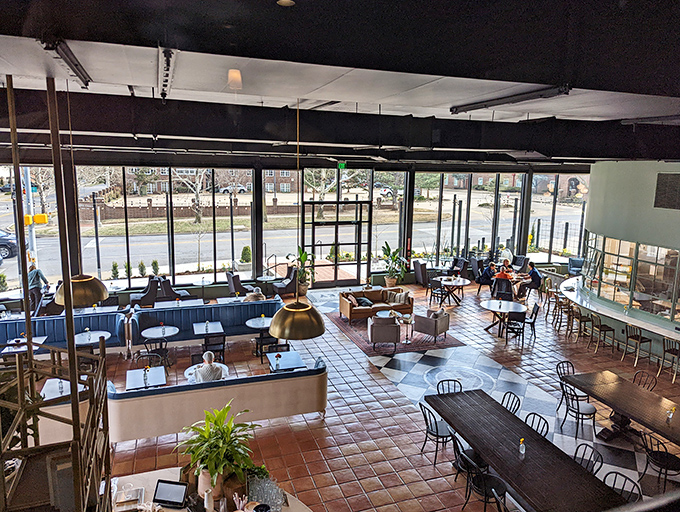 Sunlight floods through floor-to-ceiling windows, dancing across terra cotta tiles and blue banquettes&mdash;this isn't just eating space, it's breathing room for the soul.