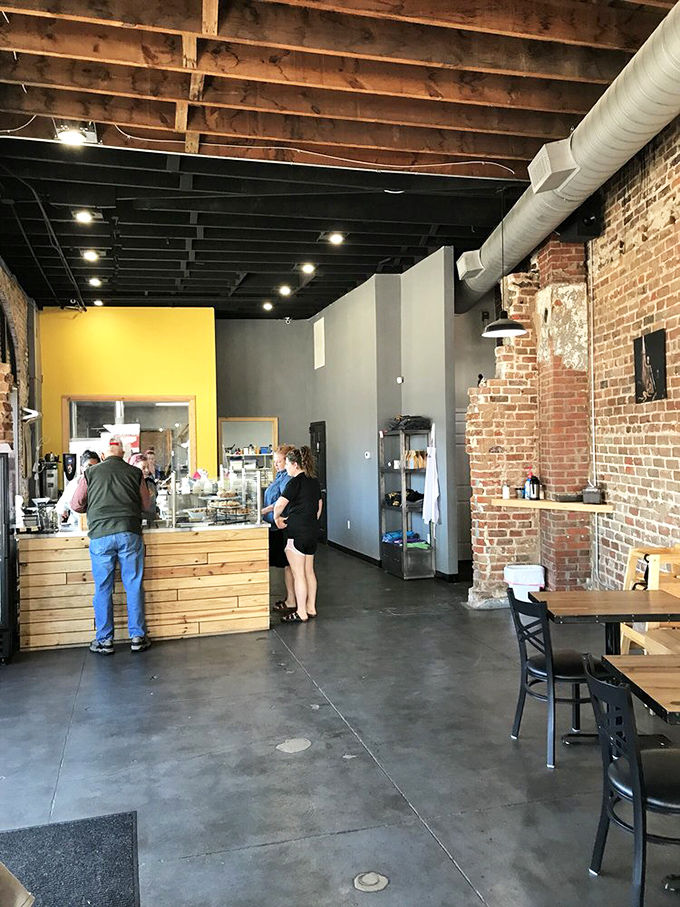 Industrial-chic meets bakery warmth with exposed brick walls, wooden beams, and concrete floors &ndash; the perfect backdrop for sugar-induced euphoria.