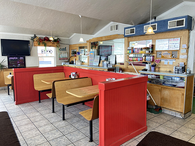 Red booth dividers and wooden seating create that perfect small-town diner atmosphere where conversations flow as freely as the coffee.