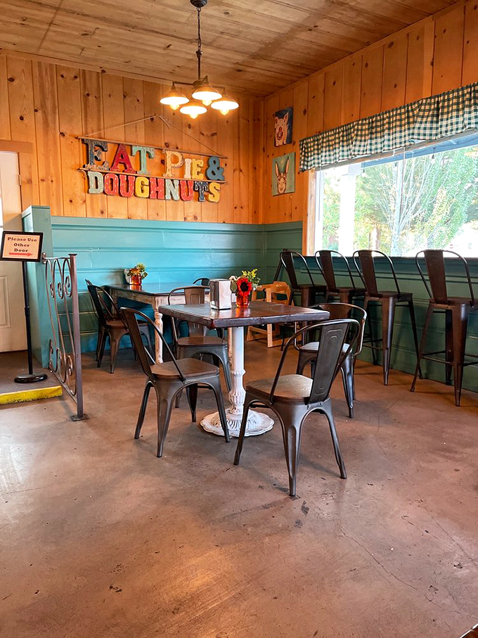 Wooden walls, metal chairs, and that "EAT PIE & DOUGHNUTS" sign&mdash;not so much d&eacute;cor as it is the world's most honest life advice.