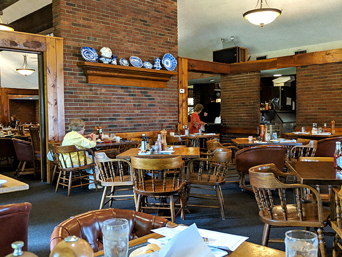 Wooden chairs, brick walls, and decorative plates create that perfect "grandma's dining room meets meat sanctuary" vibe that makes you instantly feel at home.