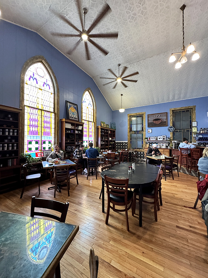 Stained glass windows bathe diners in kaleidoscopic light while ceiling fans gently circulate the heavenly aromas from the kitchen.