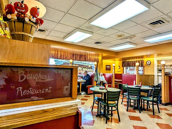 The classic diner interior at Baugher's feels like a warm hug, complete with checkered floors and those red booths where memories are made one pie slice at a time.