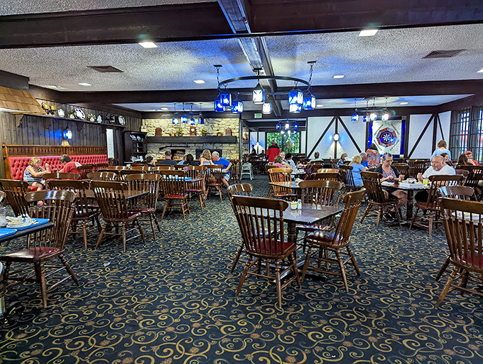 Inside, wooden chairs and blue patterned carpet create that perfect "grandma's dining room for 200" vibe that makes everyone feel instantly at home.