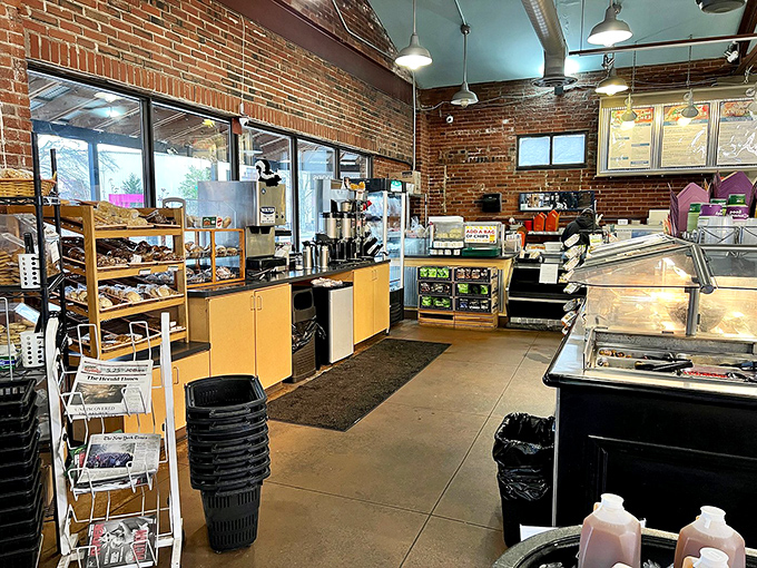 Where sandwich magic happens! The deli counter's exposed brick and wooden shelving create the perfect backdrop for the culinary artistry that unfolds daily.
