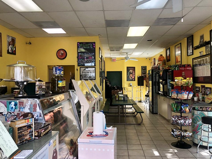 Step inside to bright yellow walls adorned with memorabilia and a deli case that promises delicious possibilities. This is sandwich sanctuary, not interior design magazine material.