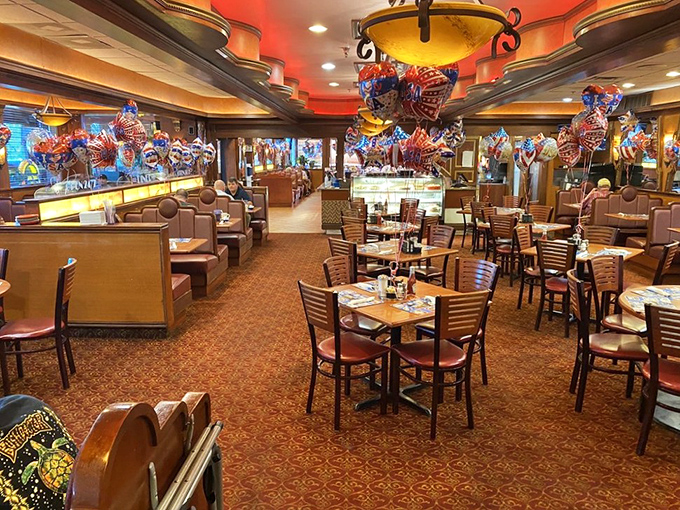 Step inside and the 1950s vibe wraps around you like a warm hug. Red booths, warm lighting, and balloons create that perfect diner atmosphere.