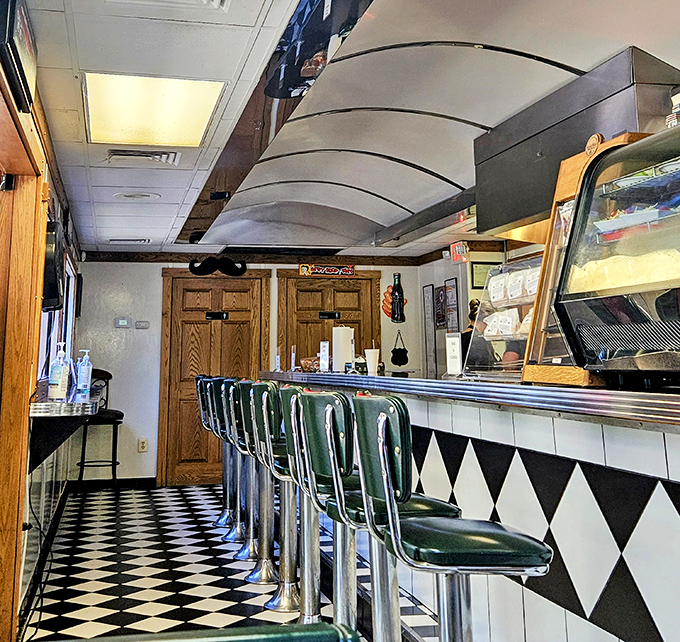 Classic green vinyl stools line the counter where elbows have polished the surface for years. This isn't retro by design&mdash;it's authentic by survival.
