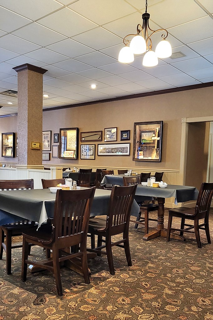 Classic wooden chairs, historical photos, and warm lighting create the perfect backdrop for comfort food conversations. It's like dining in a Norman Rockwell painting.