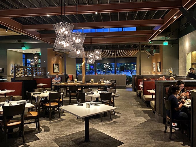 Modern rustic elegance meets thoughtful design in Redrock's dining room. Those geometric light fixtures aren't just illuminating your meal&mdash;they're setting the stage for culinary drama.