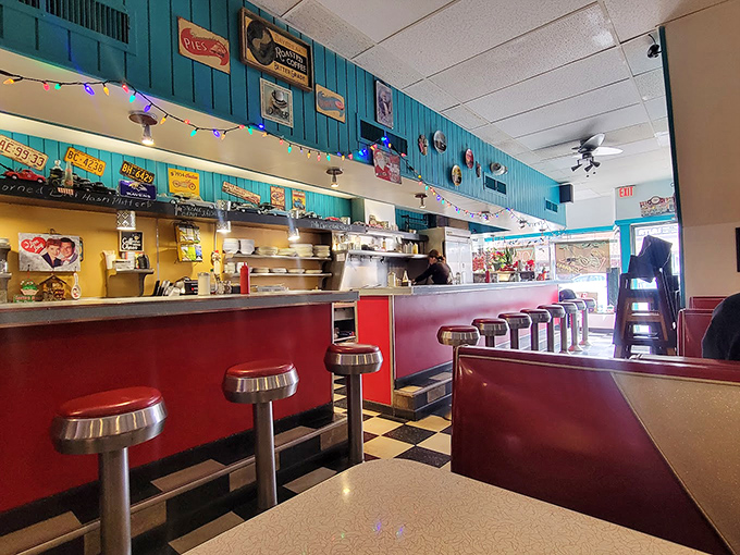 Chrome stools lined up like soldiers at the counter, ready for hungry patrons to take their positions in this turquoise-walled time capsule.