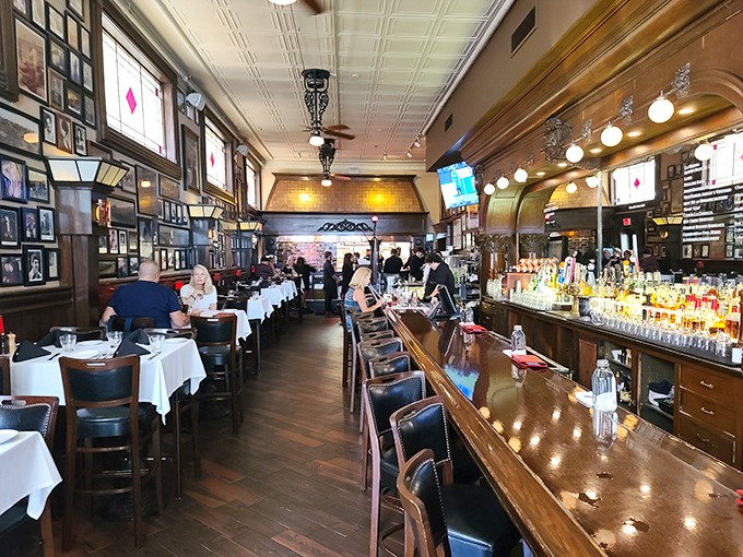 Old-school elegance meets timeless comfort inside St. Elmo's dining room, where white tablecloths, wood paneling, and walls of memories create the perfect steakhouse atmosphere.