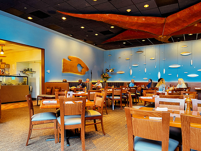 Ocean blues and suspended wooden boat hulls create an atmosphere that says "serious seafood" without shouting it through a megaphone.