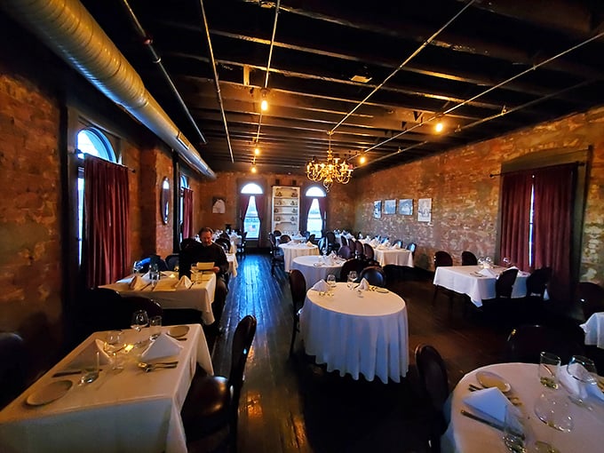 White tablecloths, exposed brick, and chandeliers create the kind of atmosphere where Frank Sinatra would feel right at home.