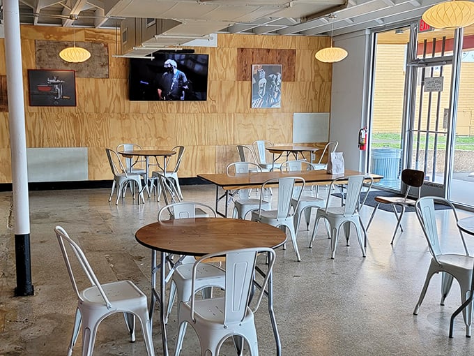 Modern meets rustic in this unpretentious dining space. Metal chairs, wooden walls, and pendant lamps create the perfect backdrop for serious sandwich consumption.