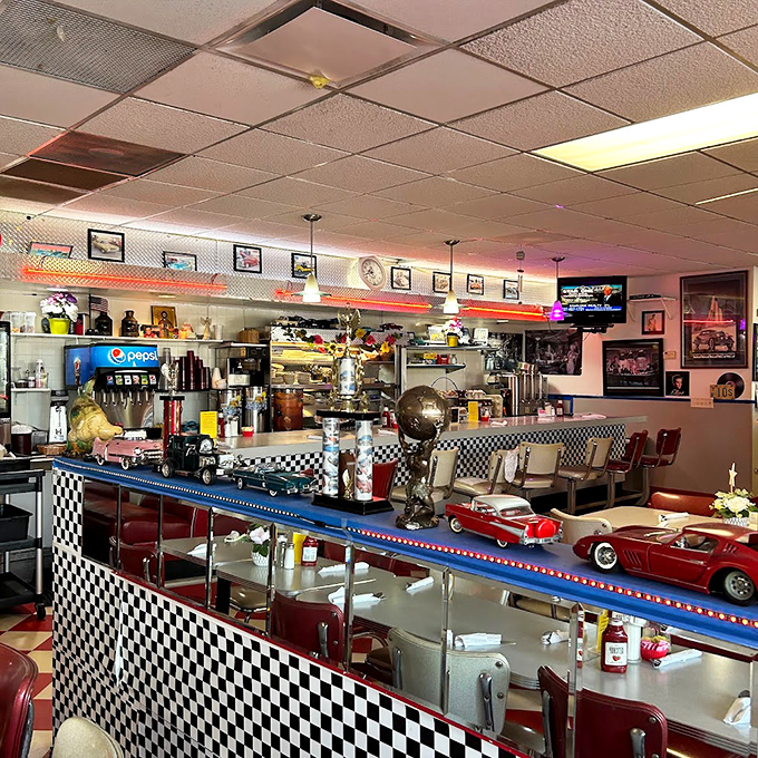 Where model cars get better real estate than most Floridians. The counter's checkerboard pattern and vintage decor create the perfect backdrop for comfort food conversations.