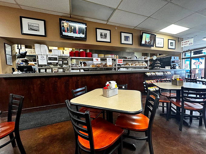Classic deli ambiance with no pretension: wood paneling, orange chairs, and the promise of sandwich artistry happening behind that counter.